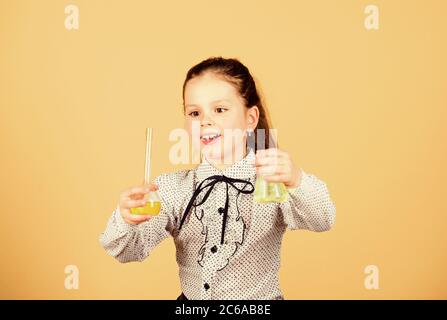 Educative experiment. Chemistry fun. Schoolgirl with colorful chemical ...