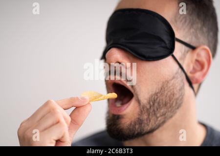 Blind Taste. Blindfolded Food Test. Man Face Stock Photo - Alamy