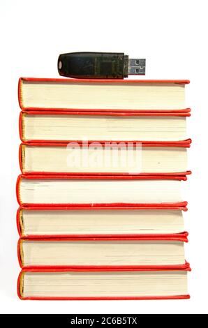 Pile of books with flash drive on top Stock Photo - Alamy