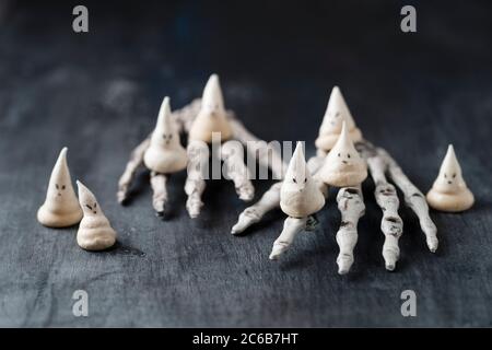 Halloween meringue ghosts on bone hands Stock Photo - Alamy