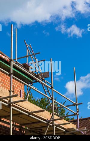 scaffolding around a house in the UK Stock Photo - Alamy