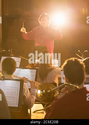Conductor leading orchestra Stock Photo - Alamy