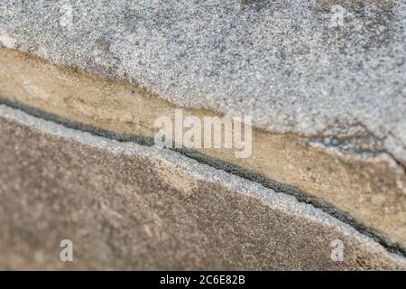 Spalling cement render of low garden wall as it separated from lower ...