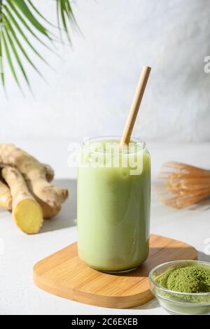 Iced green matcha latte tea on wooden table Stock Photo - Alamy