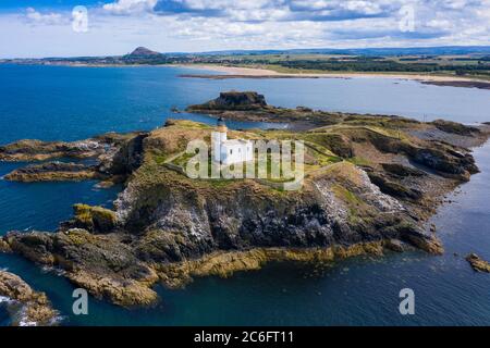Aerial view of Fidra Island and lighthouse on Firth of Forth in East ...