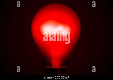 Crompton ruby red tungsten incandescent filament lightbulb lit, red ...
