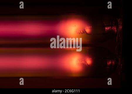 SOX Sodium, LPS or low pressure sodium lamp warming up. The pink/red ...