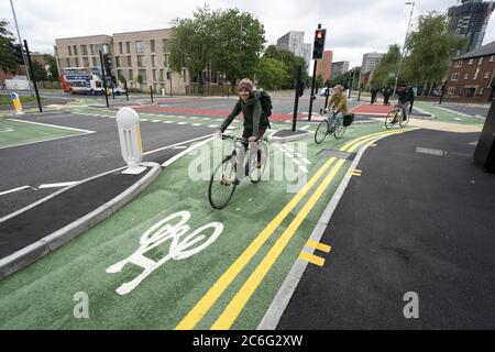 Manchester, Britain. 9th July, 2020. A cyclist waits for a traffic ...