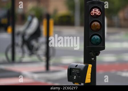 Manchester, Britain. 9th July, 2020. A cyclist waits for a traffic ...