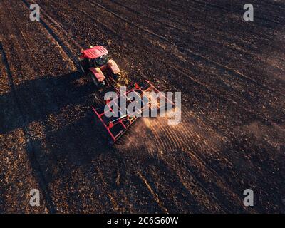 tractor - aerial view of a tractor at work - cultivating a field in ...