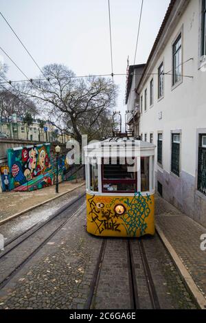 One of Lisbon's trams covered in graffiti Stock Photo - Alamy