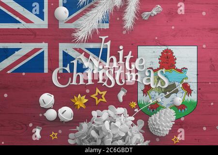 Bermuda flag on wooden table with snow objects. Christmas and new year ...