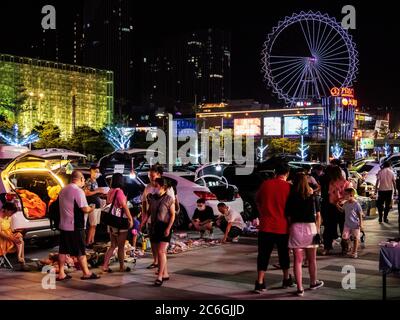 People walk and shop around at a 7-day temporary night market in ...