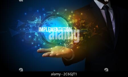 Elegant hand holding IMPLEMENTATION inscription, digital technology ...