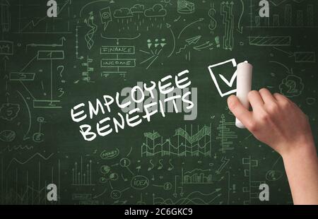 Hand drawing EMPLOYEE BENEFITS inscription with white chalk on ...