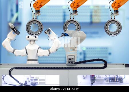 Industrial automation robotic teamwork working with circuit board on ...
