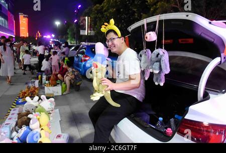 Customers wander and purchase at a trunk bazaar, where limousines ...