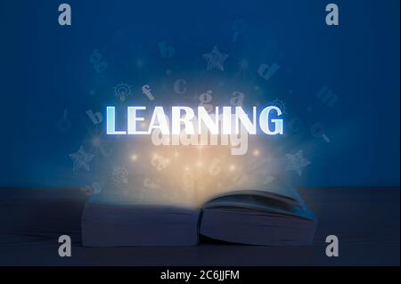 Online education concept. Light coming from open book. Open book with online education ...