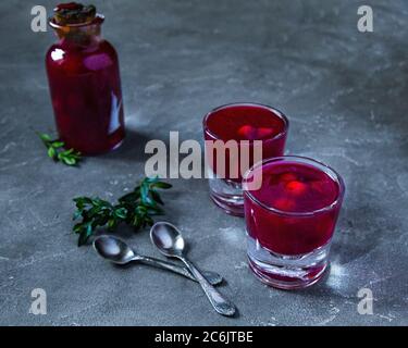 Kissel with cherries in a glass on an old wooden background ...