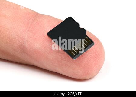 SD memory card on finger isolated on white background. High resolution ...