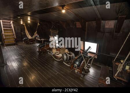 lower deck of a galleon with cannons and an hammock Stock Photo - Alamy