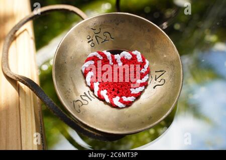 Zimbel sound instrument for relaxation with a crocheted red heart Stock ...