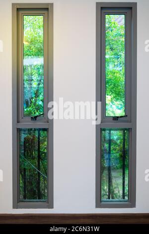 Modern window. Closed white window overlooking green garden Stock Photo ...