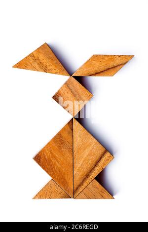 Color tangram in rabbit shape on wood background Stock Photo - Alamy