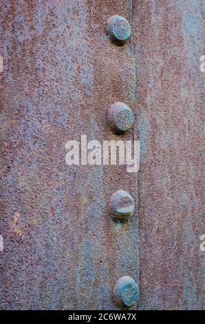 Fragment Rusty riveted hull of an old ship. Large metal rivets metal ...