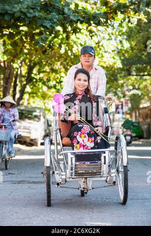 Two women sitting on a rickshaw Stock Photo - Alamy