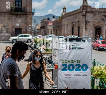 Hispanic people washing hands before entering store in Morelia Mexico ...