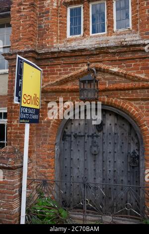 For sale sign is seen outside of a home in Northbrook, Ill., Monday ...