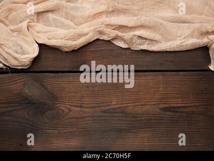 gray kitchen textile towel folded on a brown wooden table from old ...