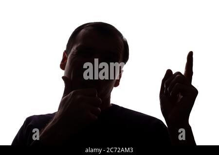 Portrait of a young man with his raised index finger, side view ...
