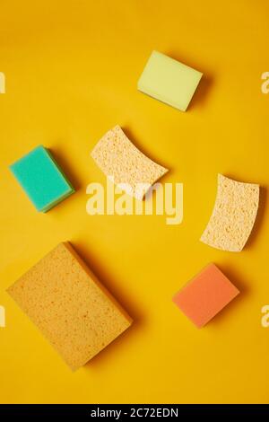 Sponges, each a different color yellow and blue near kitchen scrub ...