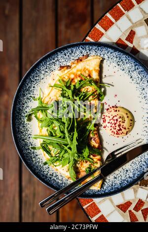 Delicious breakfast on terrace with omelette and apricot sauce and ...