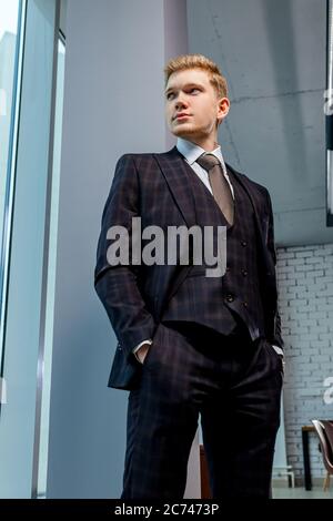 Team of young people near grey wall in office Stock Photo - Alamy