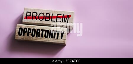 Problem crossed out and opportunity on wooden blocks. Business startup ...