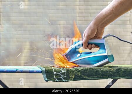 House fire caused by faulty clothes iron. Overheating electrical home ...