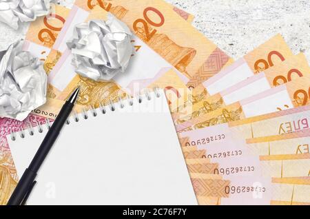 20 Belorussian rubles bills and balls of crumpled paper with notepad ...