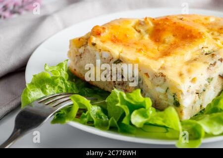 Delicious homemade fish pie with greens on a plate. Mediterranean dish ...