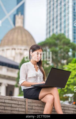 young Asian woman professional typing laptop computer working online ...