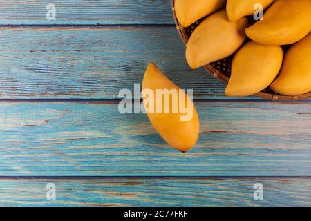 Yellow Fresh mangos 0n wood table. Mango tropical fruit on wood ...