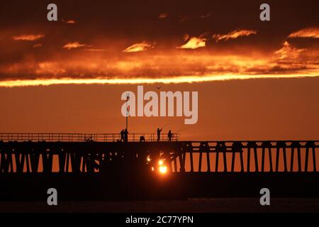 Fishermen on Blyth pier in Northumberland, fishing for mackerel as the ...