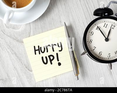 Hurry up message on adhesive note on office table Stock Photo - Alamy