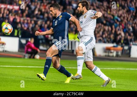 John McGinn of Scotland and Georgi Dzhikiya of Russia during the ...