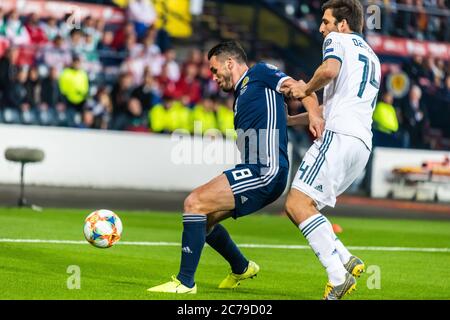 John McGinn of Scotland and Georgi Dzhikiya of Russia during the ...