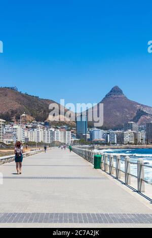 Mountains, hotels and deep blue water with waves at the Sea Point ...