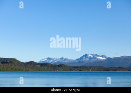 Lake Iliamna, Alaska, under a clear blue sky, with calm waters ...