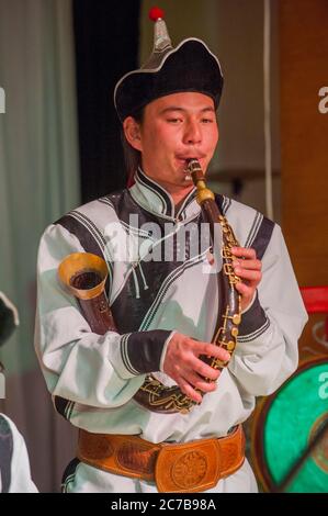 A Mongolian musician is playing the Bishguur, a traditional Mongolian ...